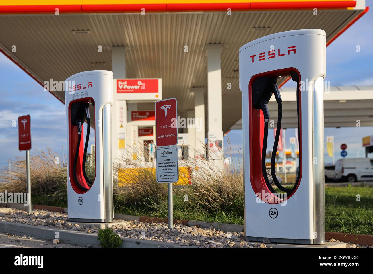 Tesla Superchargers seen at a Shell petrol station. (Photo by Filip ...