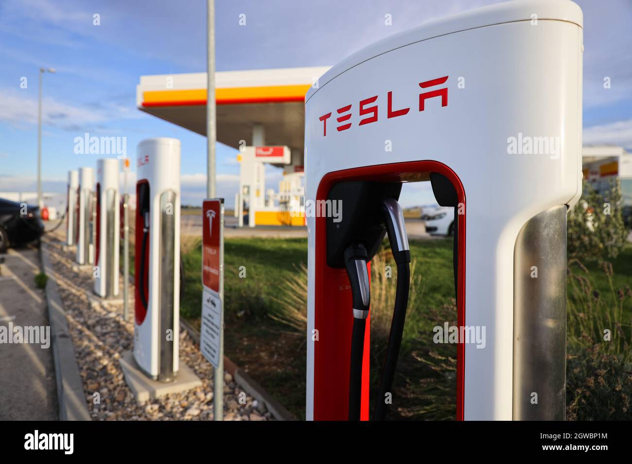 Tesla Superchargers seen at a Shell petrol station. (Photo by Filip ...