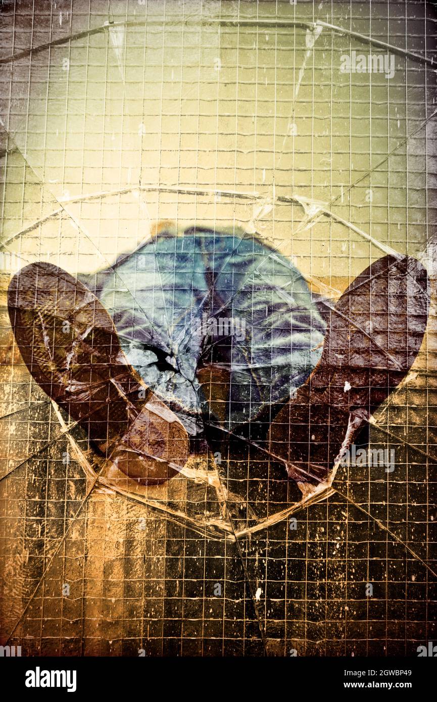 figure of a man corpse n ground behind a broken glass Stock Photo - Alamy