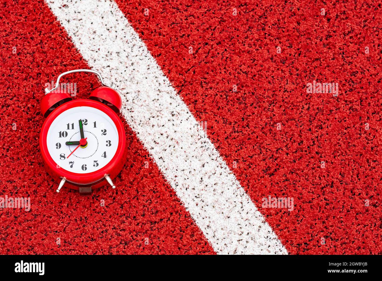 Fitness concept. Alarm clock on the start line in sports stadium ...