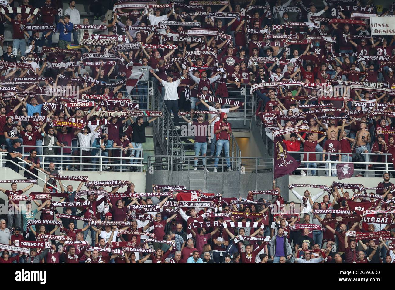 Turin, Italy, 2nd October 2021. Torino FC fans hold up their scarves as ...