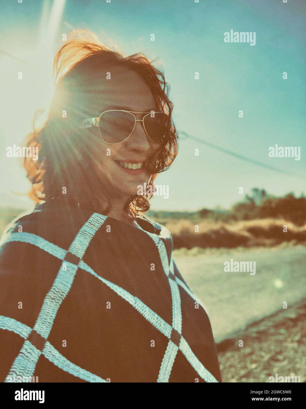 Portrait Of Smiling Mature Woman Wearing Sunglasses At Beach Stock