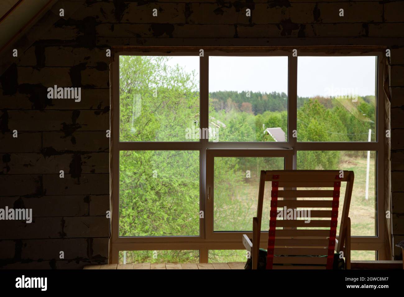 The wooden chair inside house view from window Stock Photo - Alamy