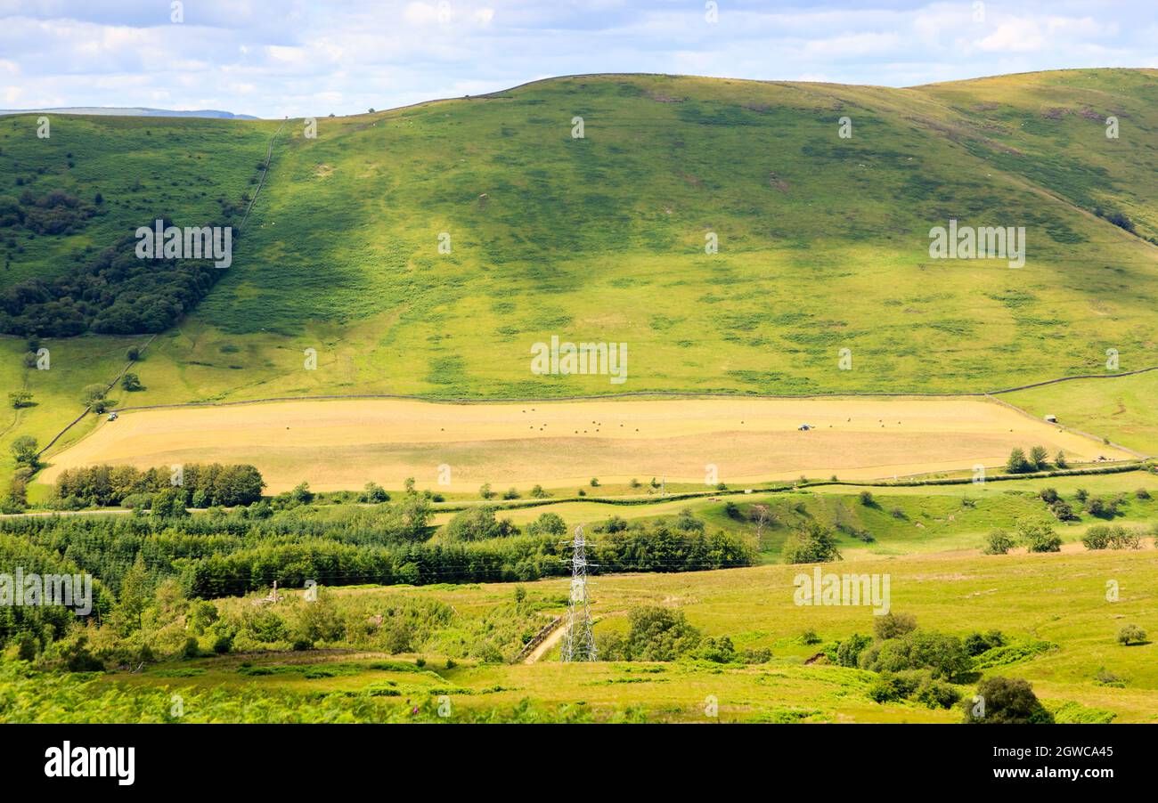 View over Langholm Moore Scotland with farmland and tractor collecting ...