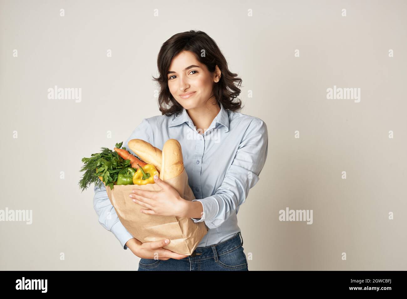 brunette with a package of products healthy food organica Stroymarket Stock Photo - Alamy