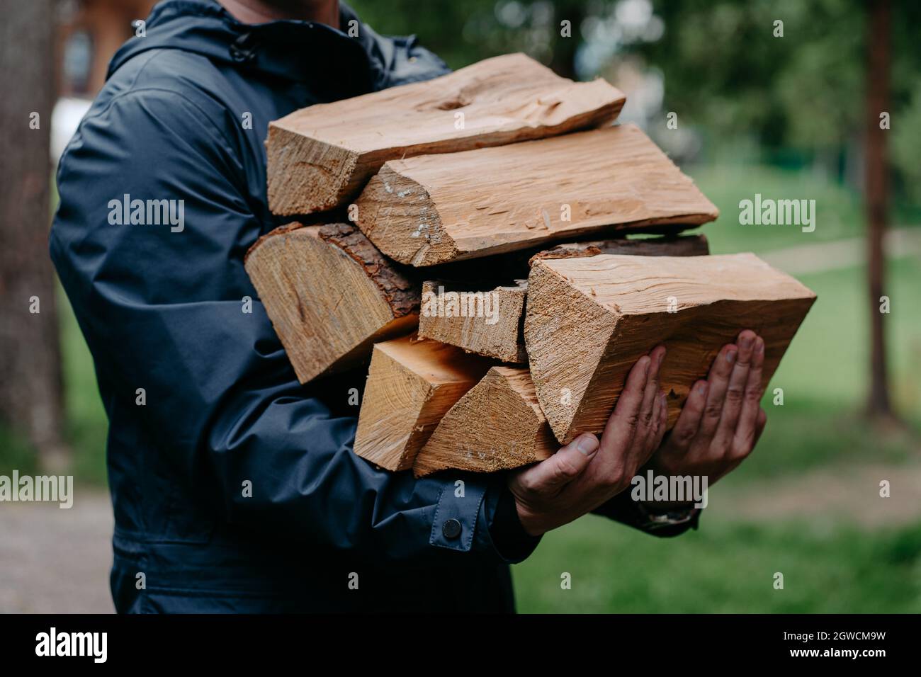 Man carrying fire wood hi-res stock photography and images - Alamy