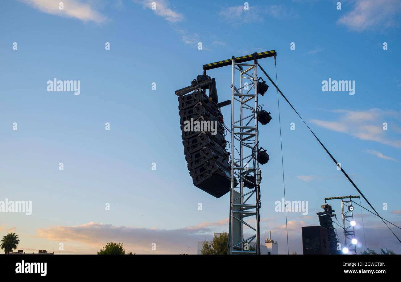 Line array speaker system hanging from pole during daylight performance ...