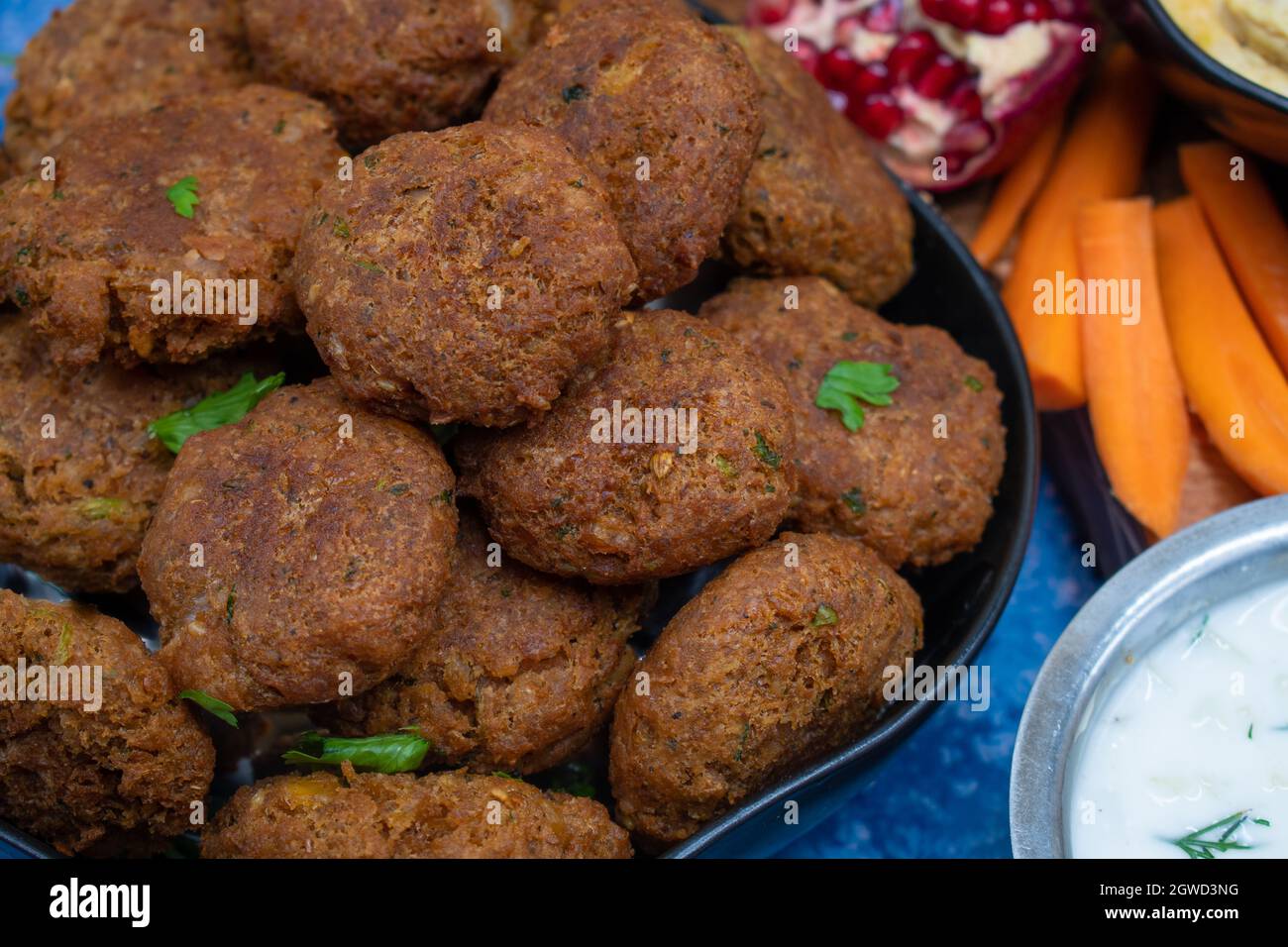 Falafel close up in black bowl Stock Photo - Alamy
