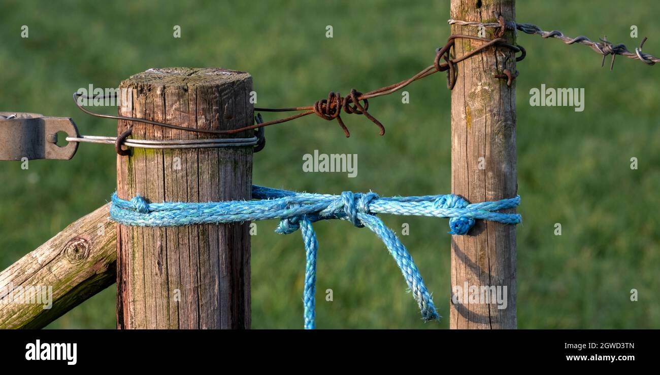 Tied to barbed wire fence hi-res stock photography and images - Alamy