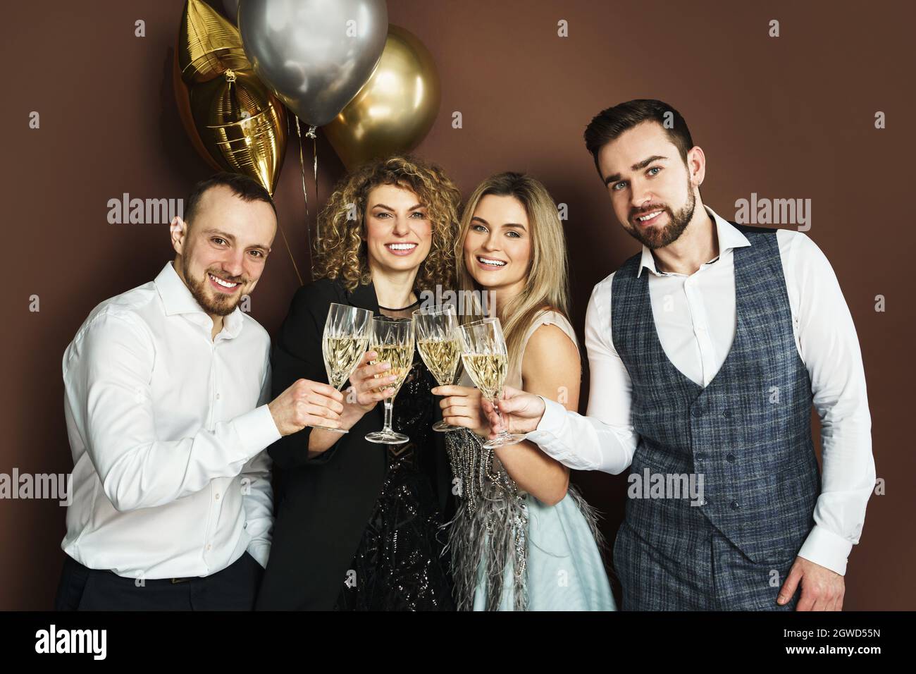 Group of beautiful well dressed party people celebrating holiday or ...