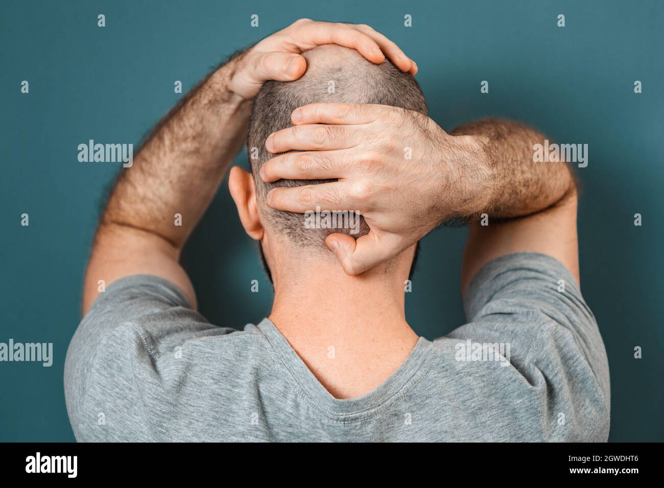 Self-doubt and inferiority complex. Baldy brunette man grabs his head ...