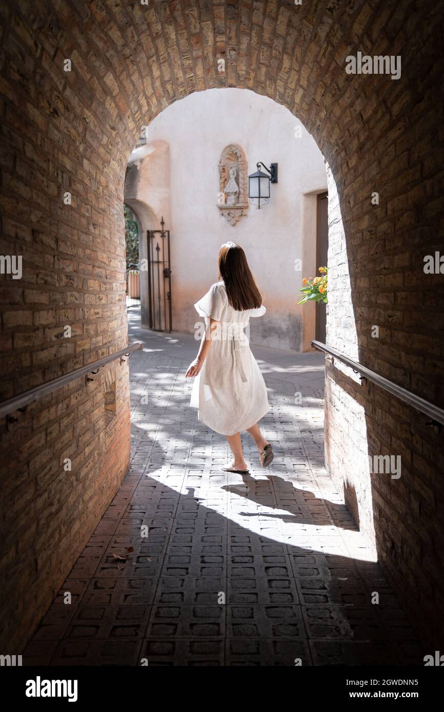 Woman walking through tunnel rear view hi-res stock photography and ...