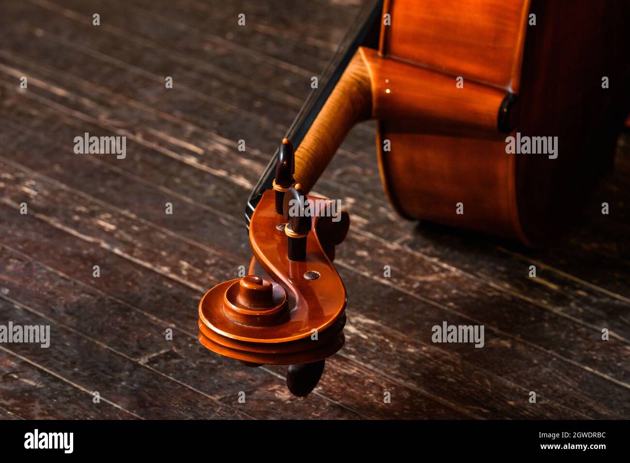 Upper spiral part of a cello lying on the stage in a diagonal angle ...