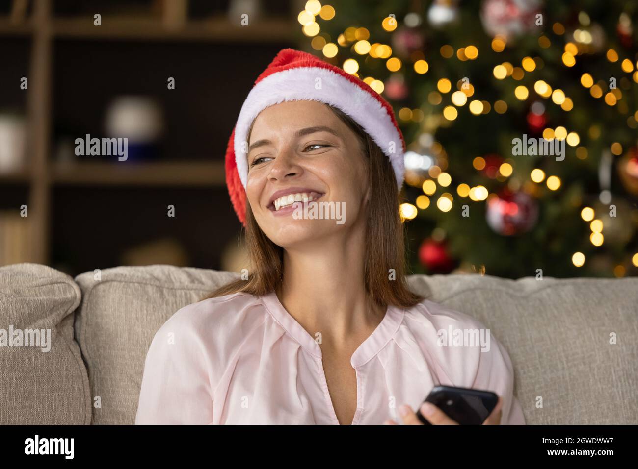 Happy young woman enjoying Christmas eve at home Stock Photo - Alamy