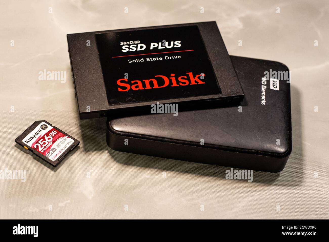 Sandisk SSD hard drive and Kinston SD card Stock Photo - Alamy