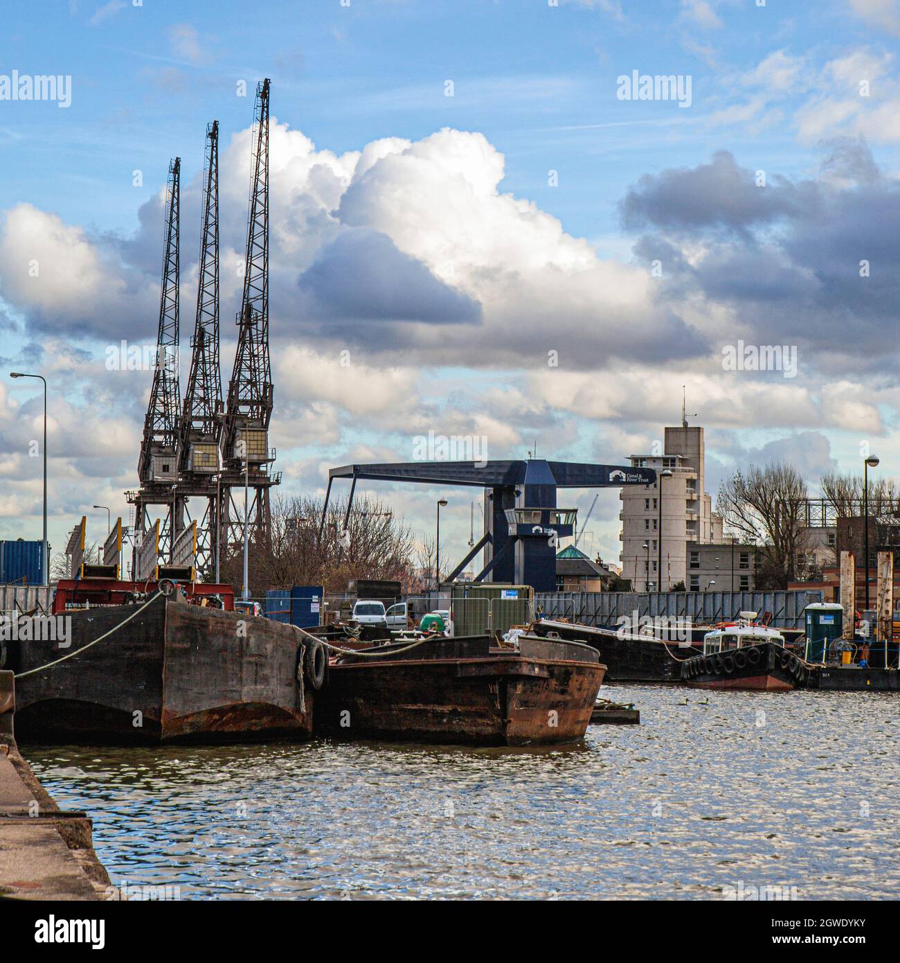 West India South Dock with cranes, blue bridge & rusty boats, Isle of ...