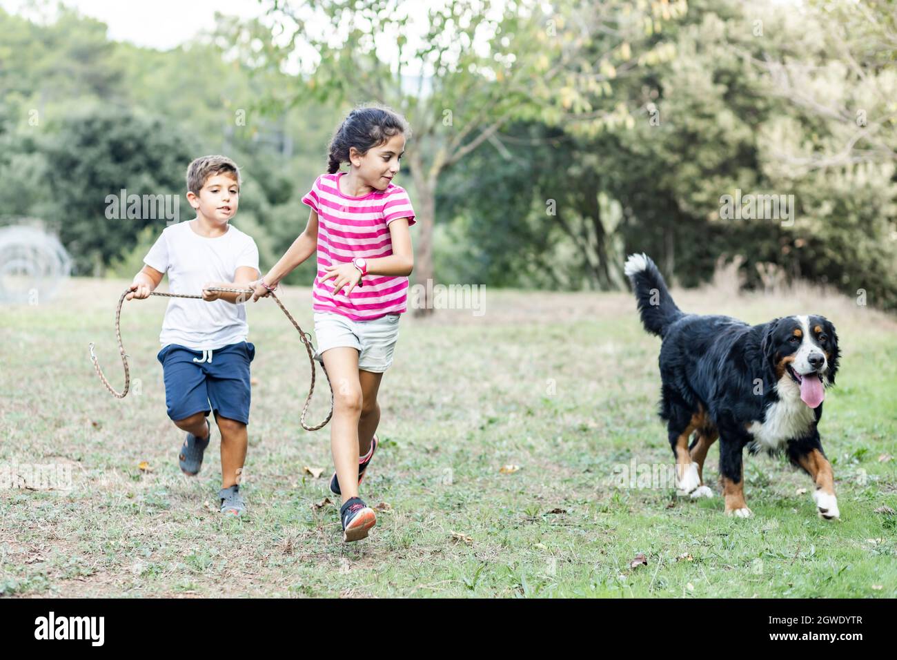 Two girls running with dog hi-res stock photography and images - Alamy