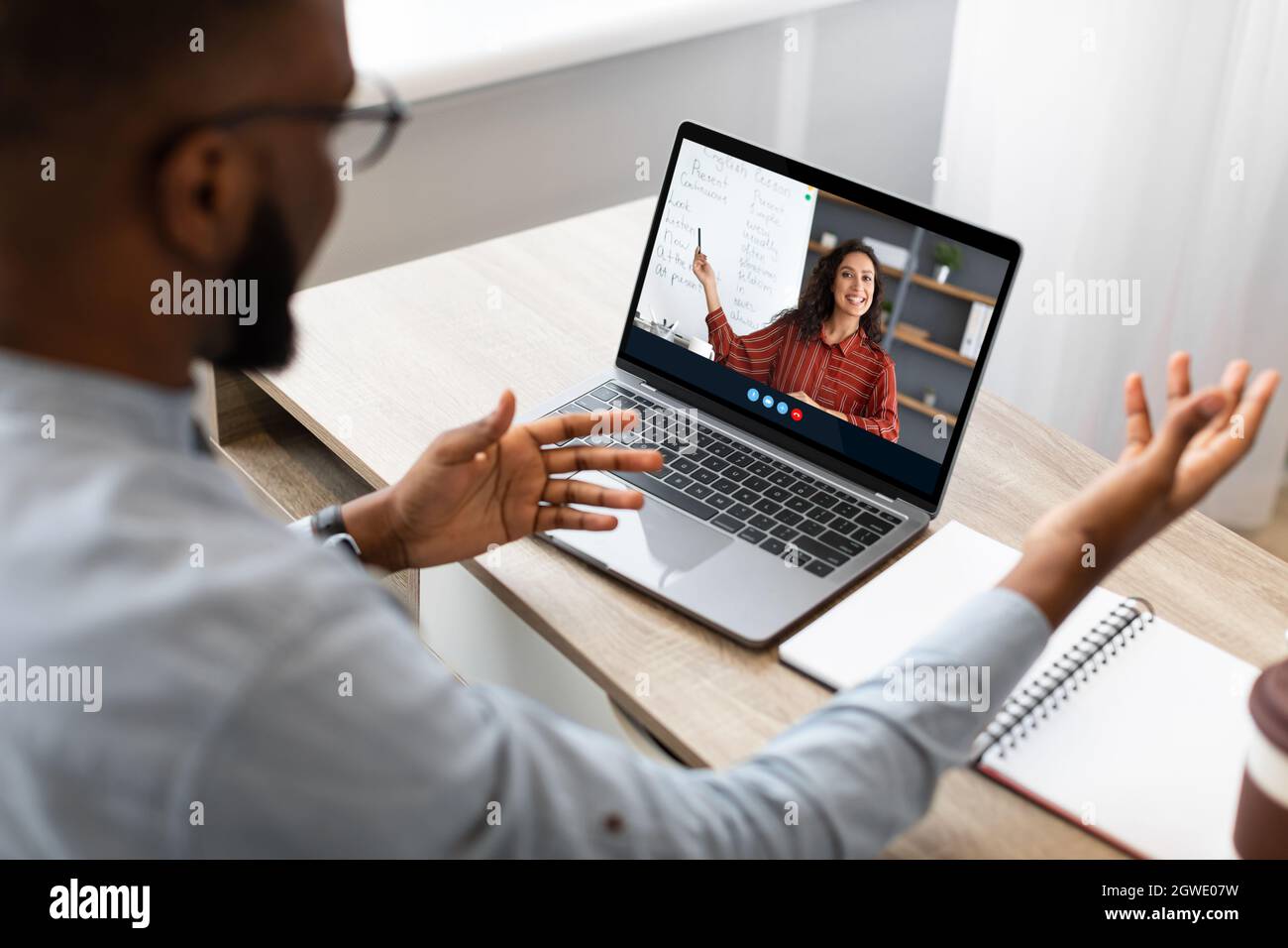 Millennial african american guy student studying with teacher remote ...