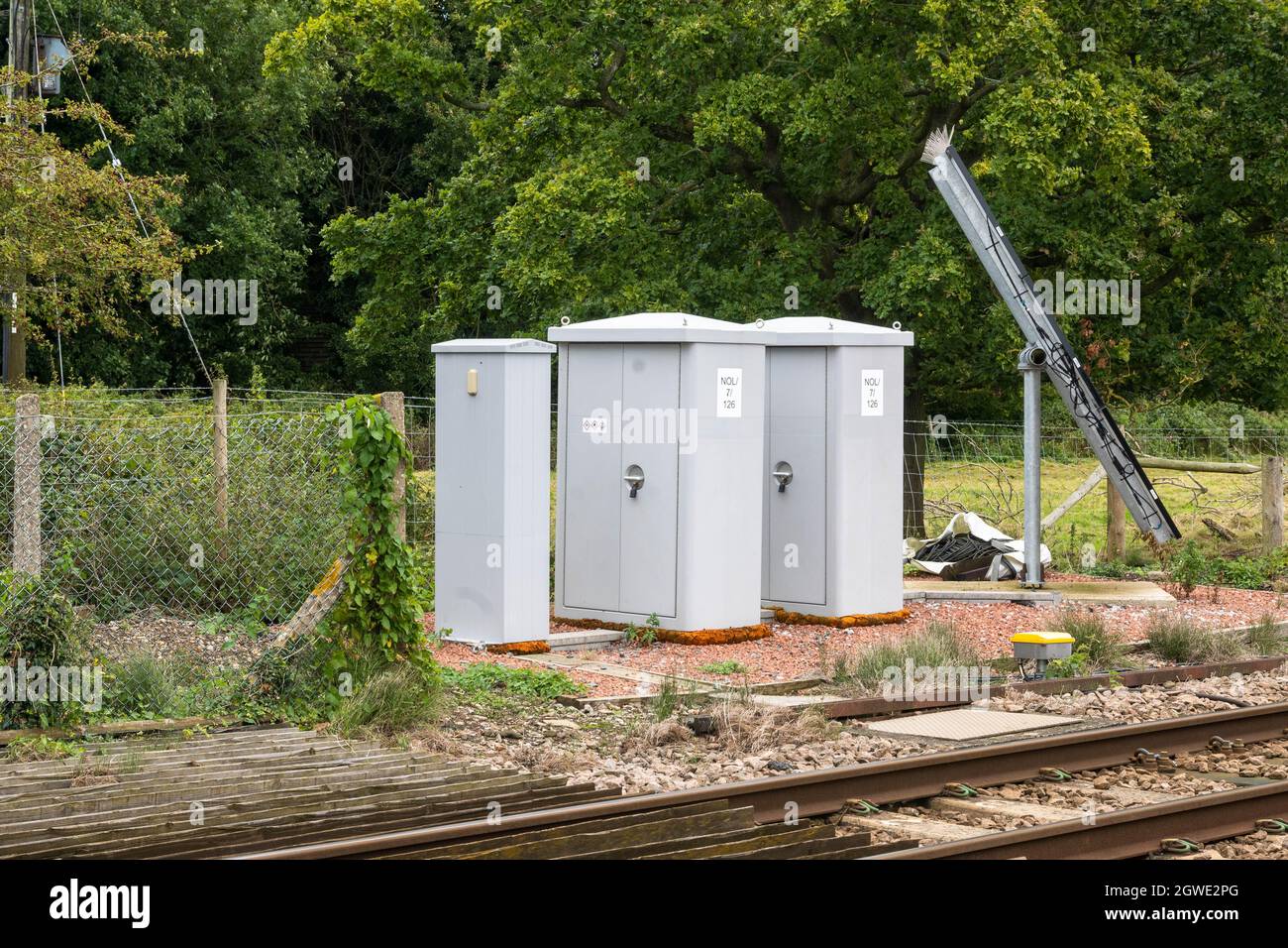 Three metal large boxes at the side of the train line at Buckenham ...