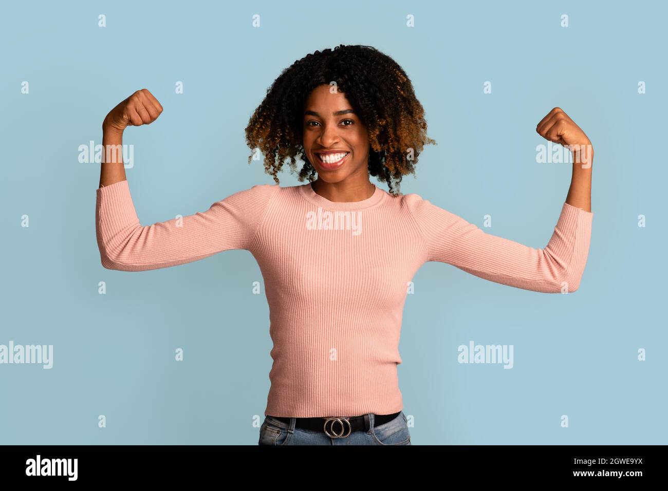 Women muscle strength showing biceps hi-res stock photography and ...