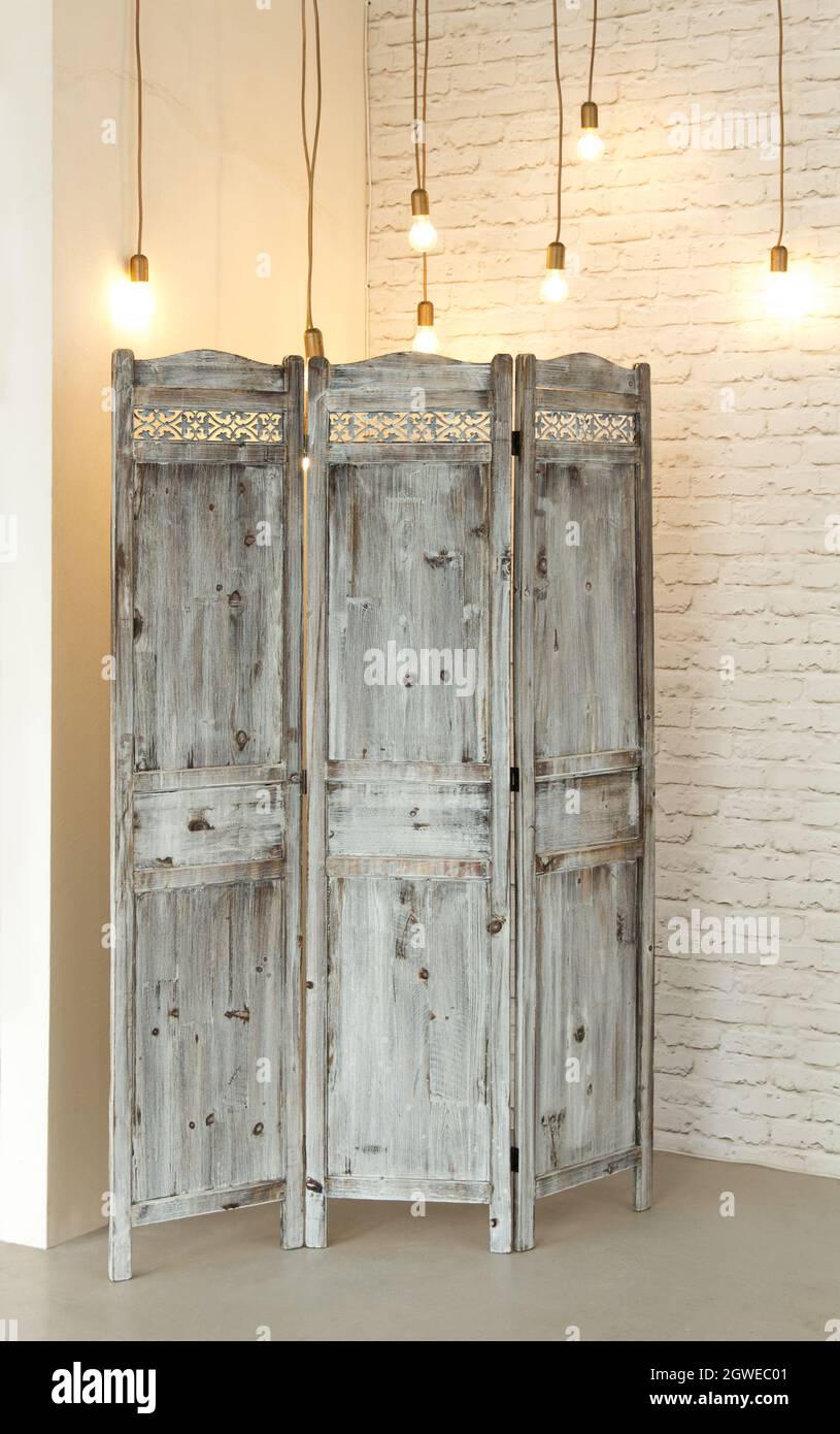 beauty wooden screen with decorative pattern cut in wood stands in room ...