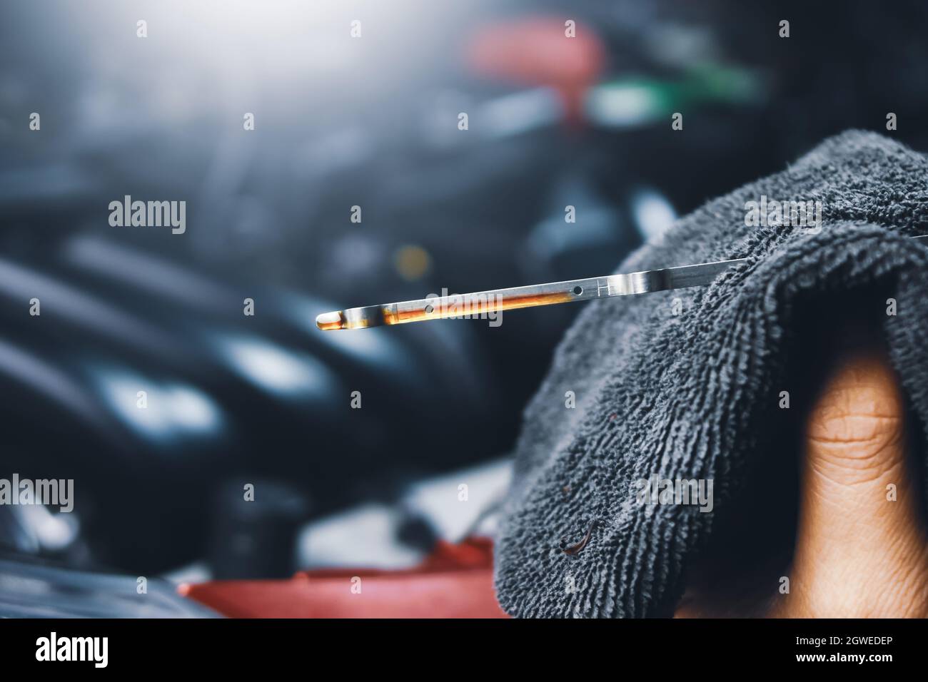 Mechanic checking a level oil dipstick of the engine car, Car maintenance service concept Stock ...