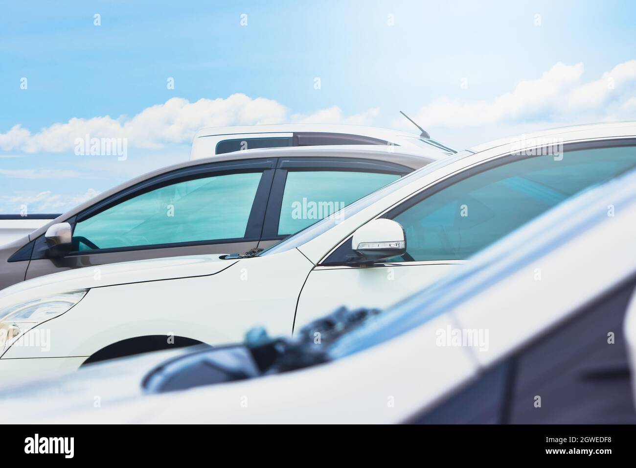 The car is parked in the parking lot with a cloud and blue sky ...