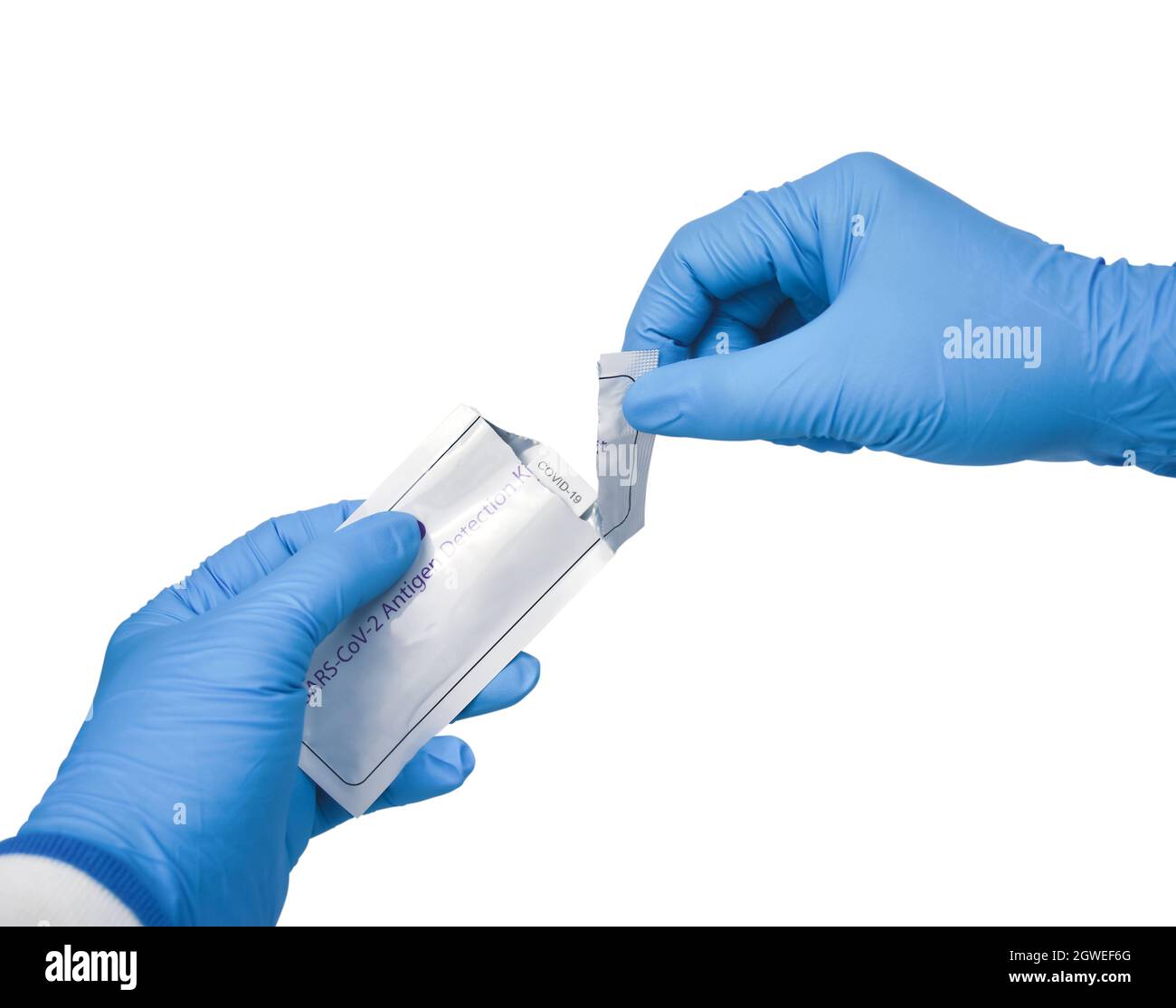 Medical personnel hand tearing envelope of Covid-19 antigen rapid test ...