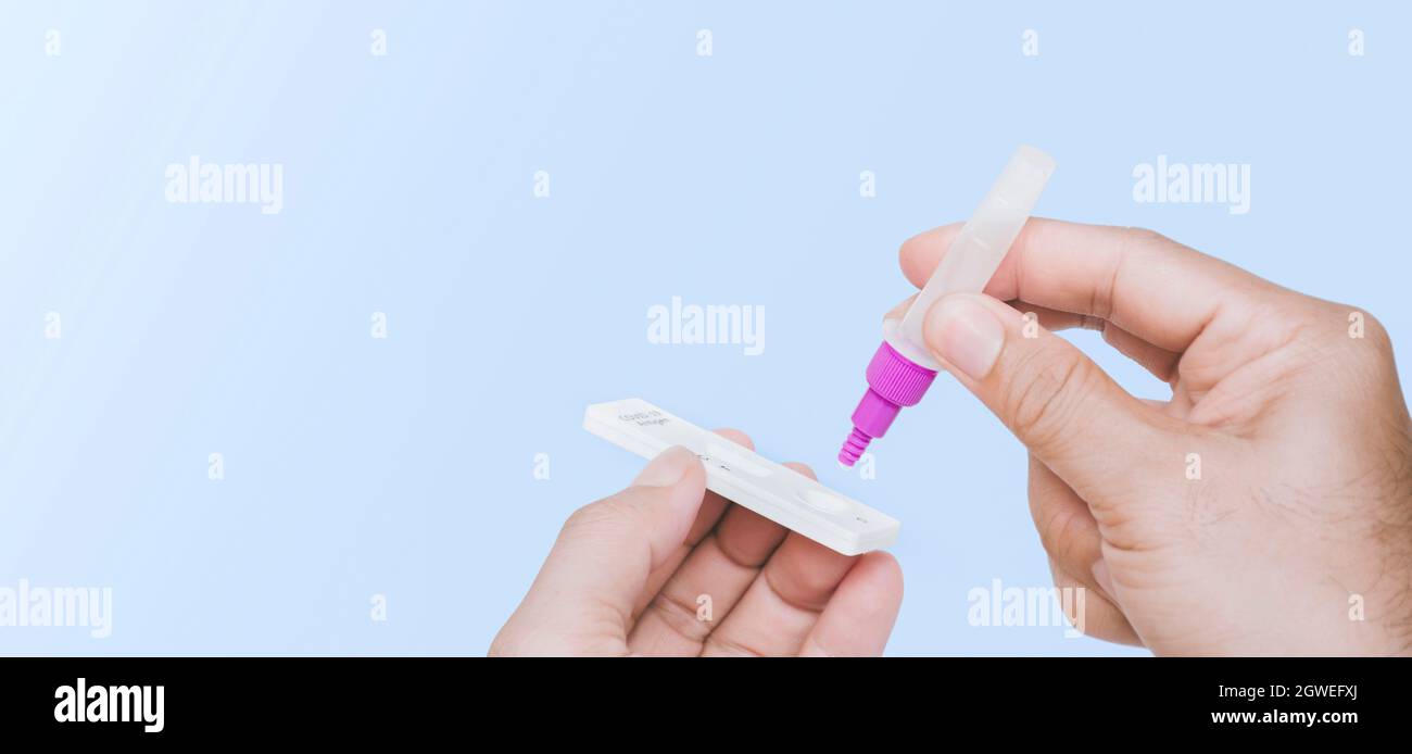 Own hand placing the secretions sample into the SARS CoV-2 Rapid ...