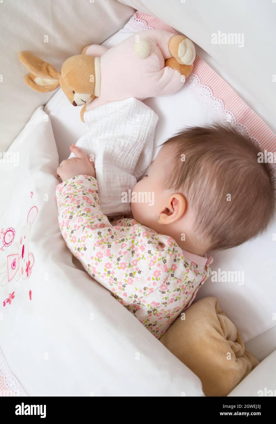 Newborn Baby Girl Sleeping In Crib