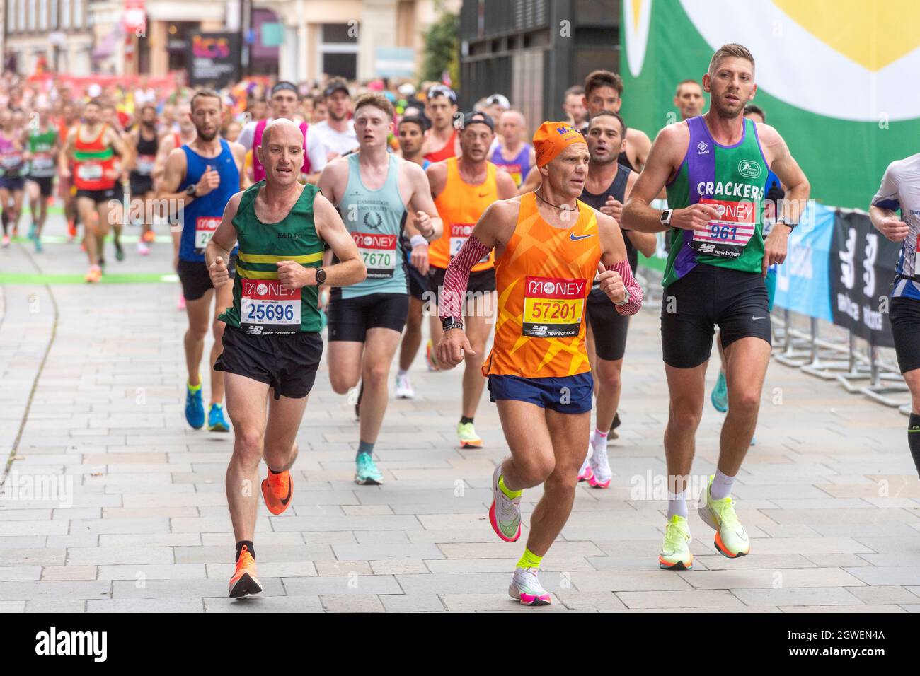 03/10/2021. London, UK. Runners run past the Cutty Sark during the ...