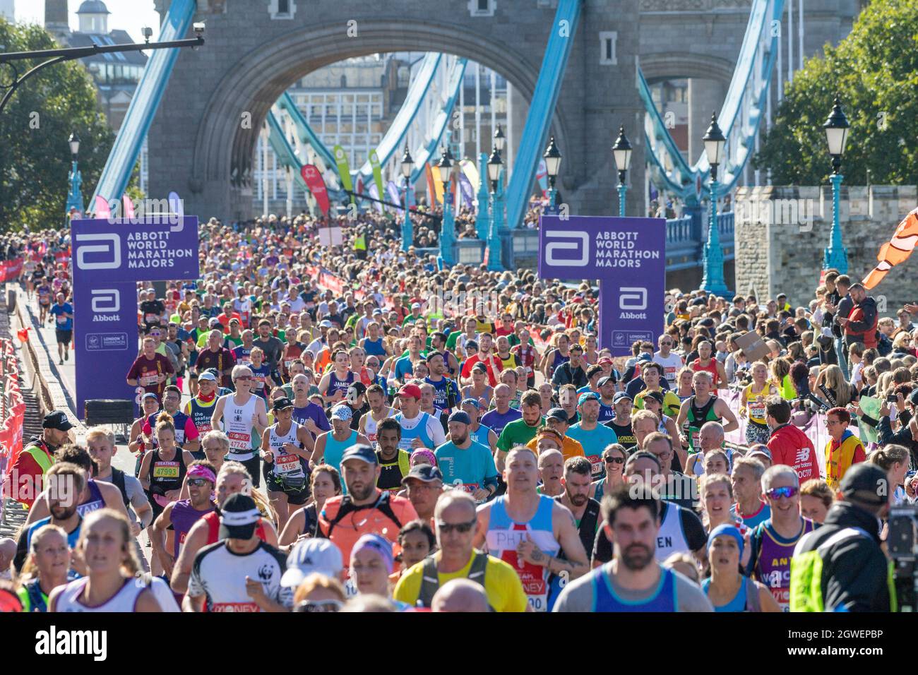 03/10/2021. London, UK. Runners run across Tower Bridge during the ...