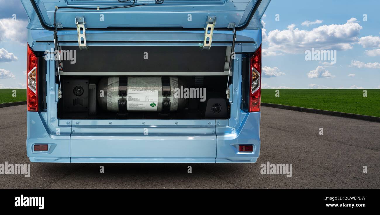 A hydrogen fuel cell bus with an open hood and a hydrogen cylinder ...