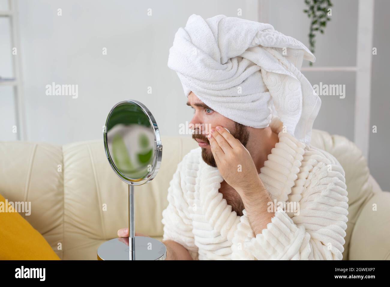 Handsome man cleaning face skin with cotton pads. Spa, body and skin ...