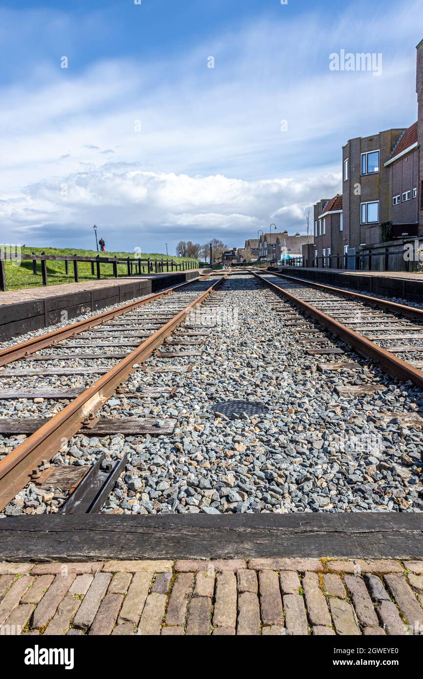 Two parallel train tracks with their rusty rails and wooden sleepers ...