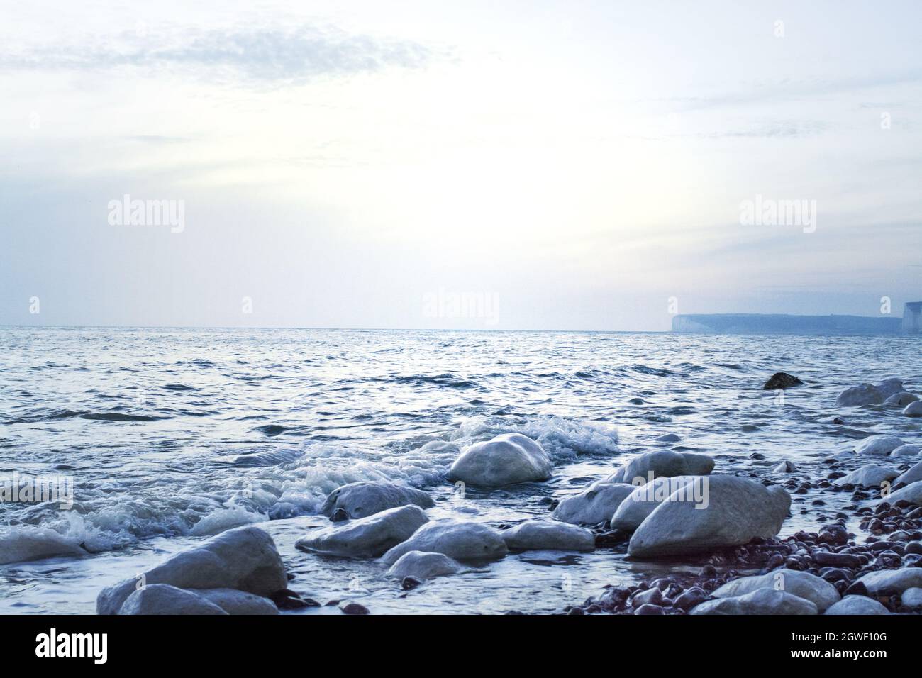 Blue cold water and rocks, bright ligsh Stock Photo - Alamy