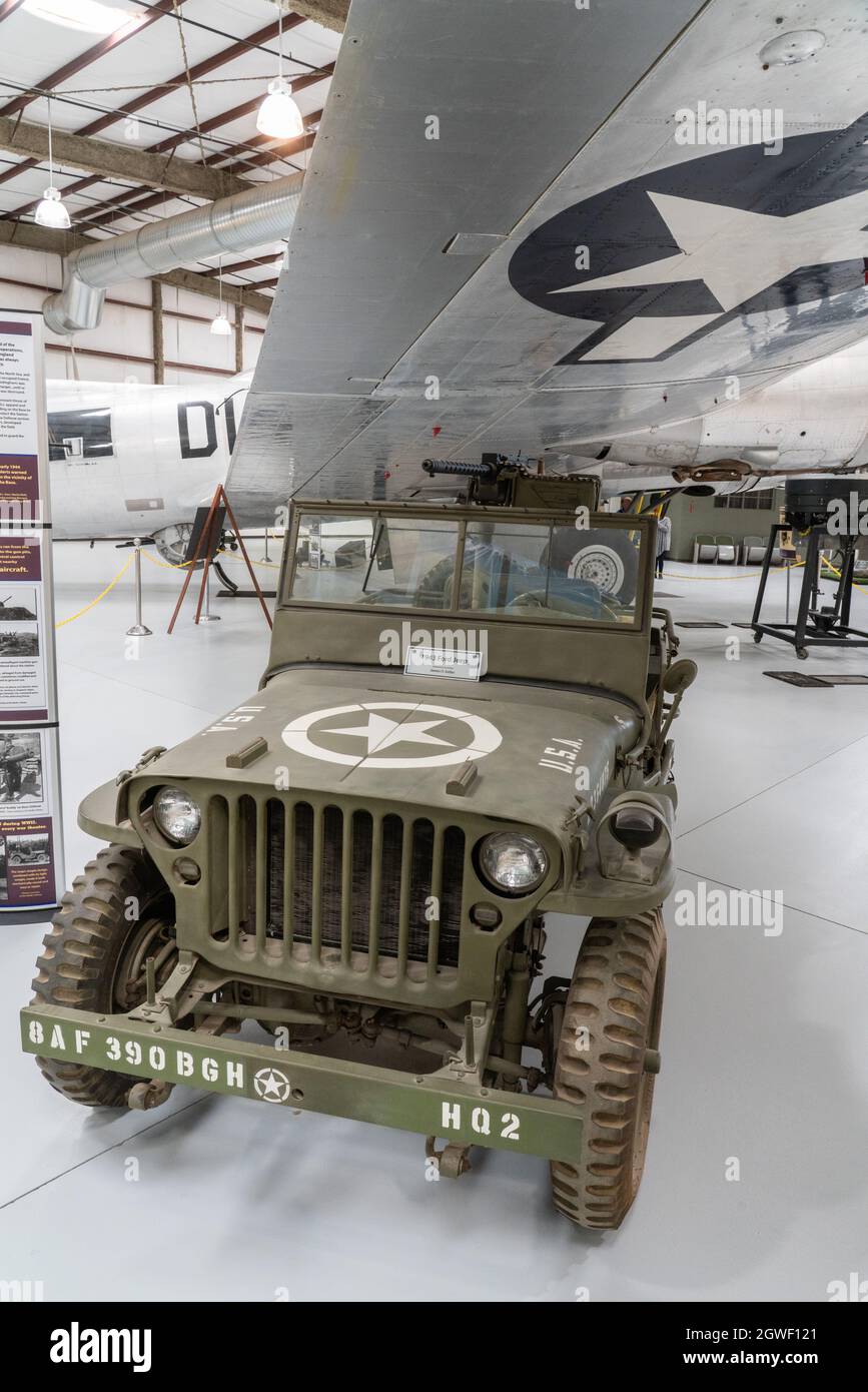 A WW II Jeep under the wing of a Boeing B-17G Flying Fortress bomber in ...