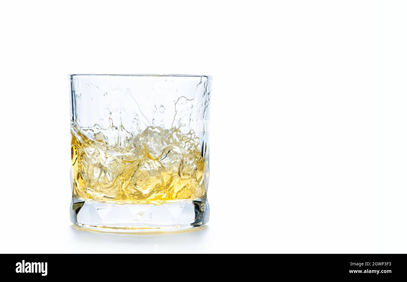 drop ice cubes in to whiskey in rock glass or Old Fashioned glass isolated on white background ...
