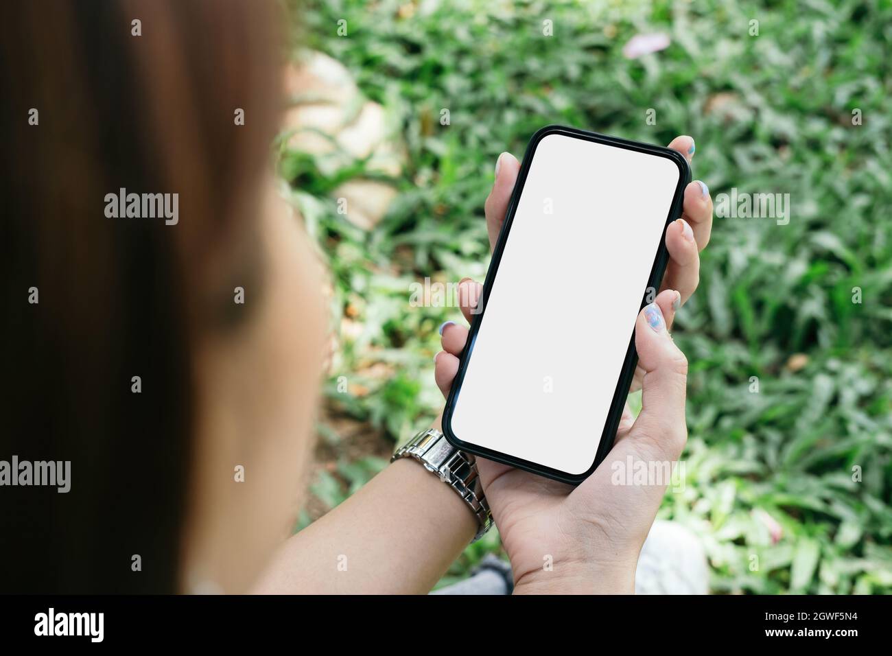 mockup image cell phone blank white screen for text. woman hand holding ...