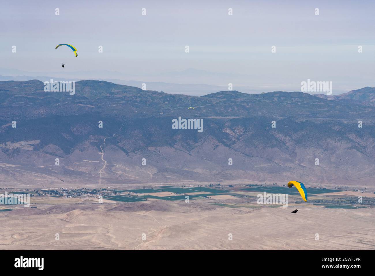 Four paragliders soar over the Sevier Valley with the Pahvant Range in ...