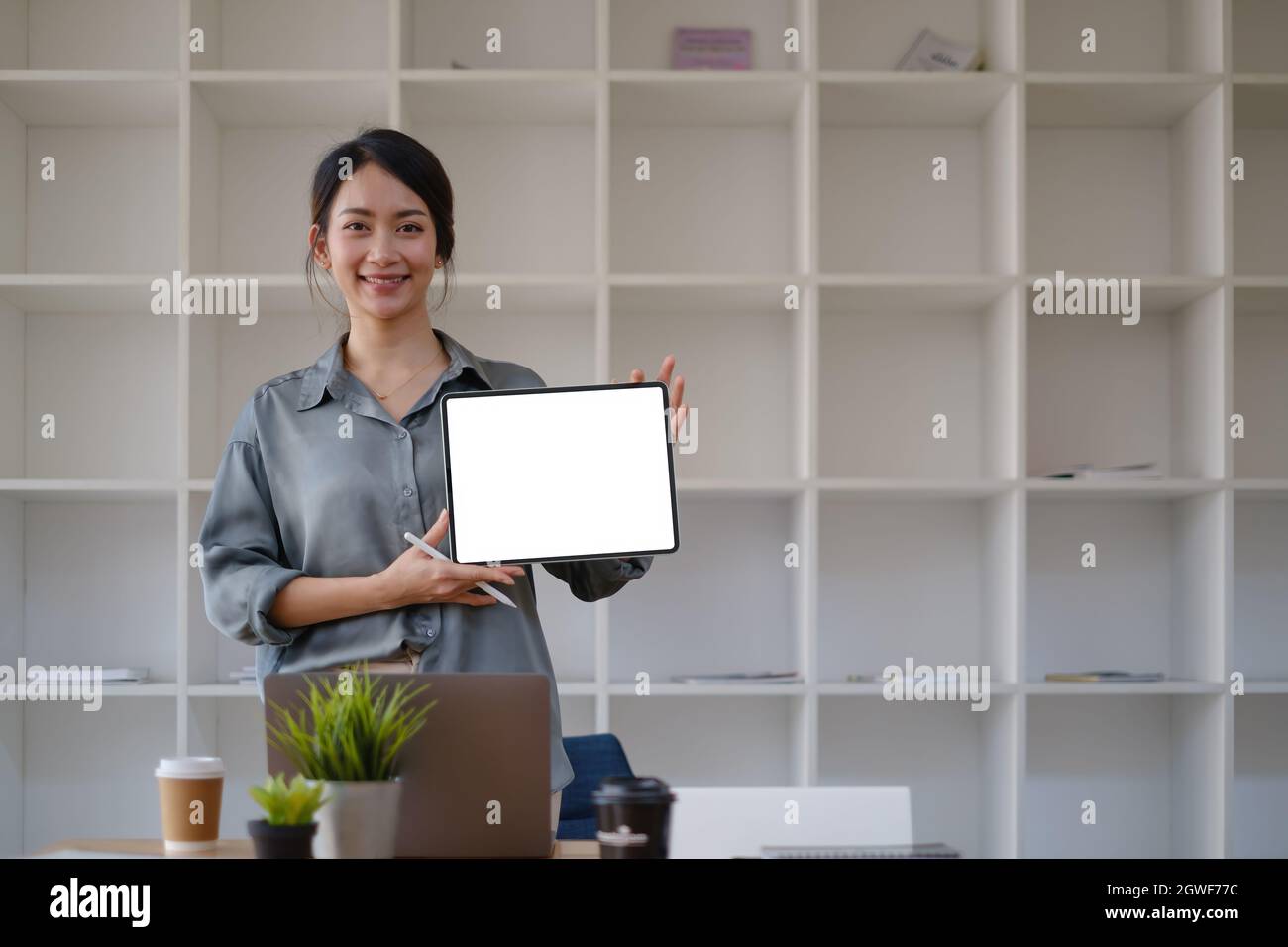 A Woman excited surprise and showing digital tablet white screen. Blank ...
