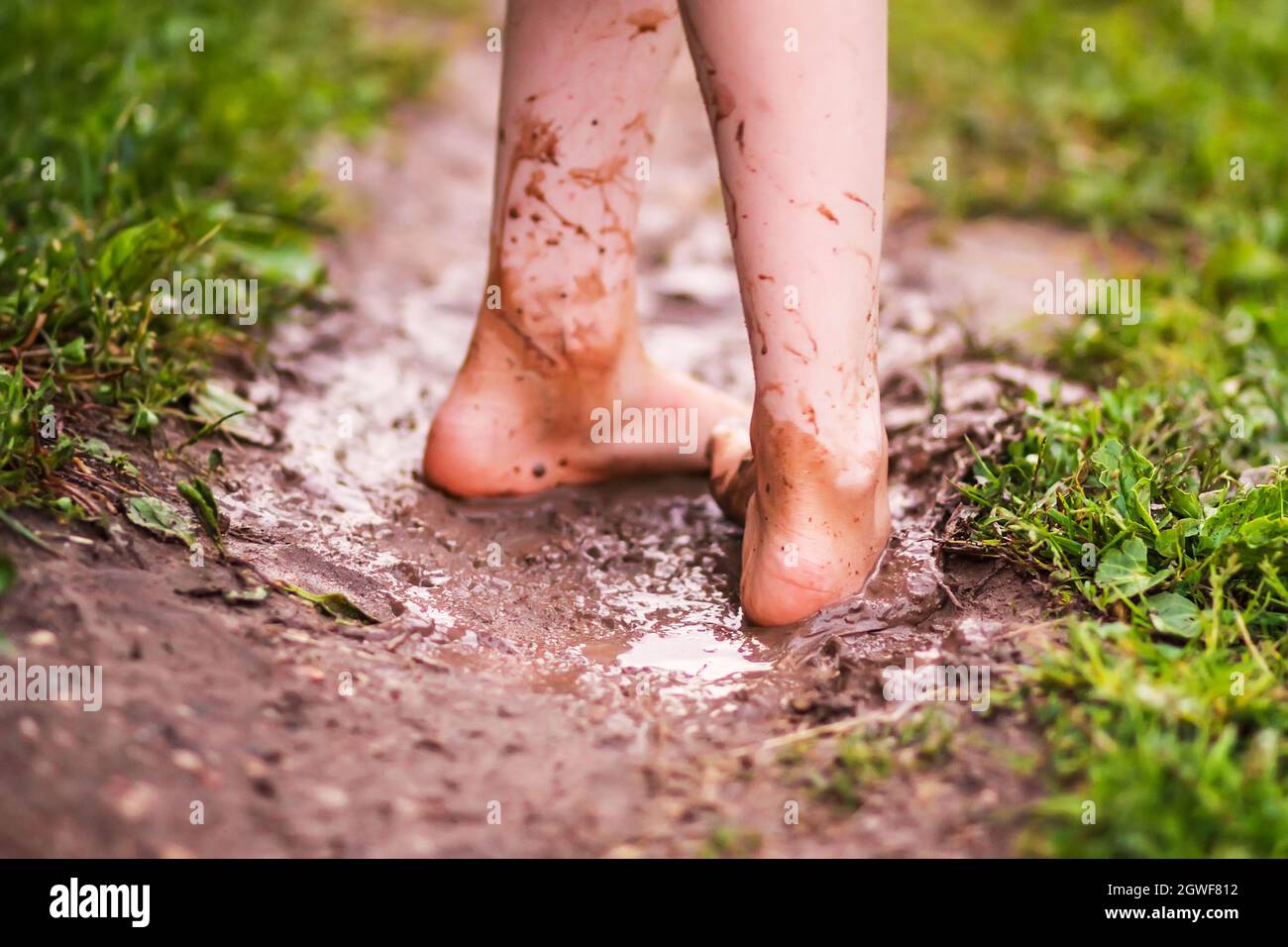 Child running in a puddle hi-res stock photography and images - Alamy