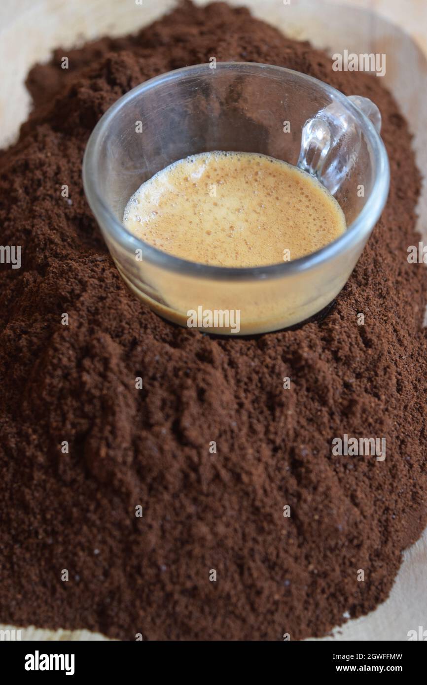 restricted espresso dipped in ground coffee Stock Photo - Alamy