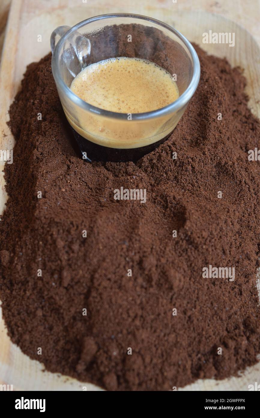 restricted espresso dipped in ground coffee Stock Photo - Alamy