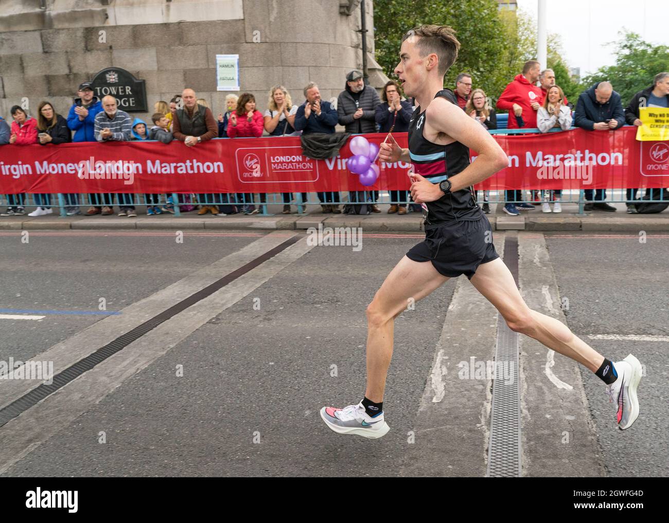 Runners completing the 41st London Marathon running over Tower Bridge ...