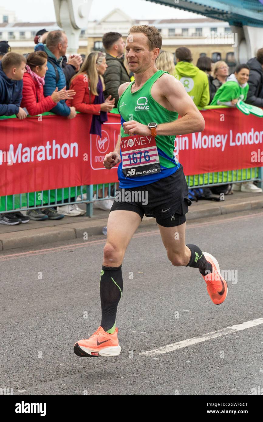 Runners completing the 41st London Marathon running over Tower Bridge ...