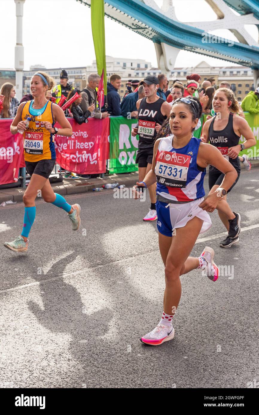 Runners completing the 41st London Marathon running over Tower Bridge ...