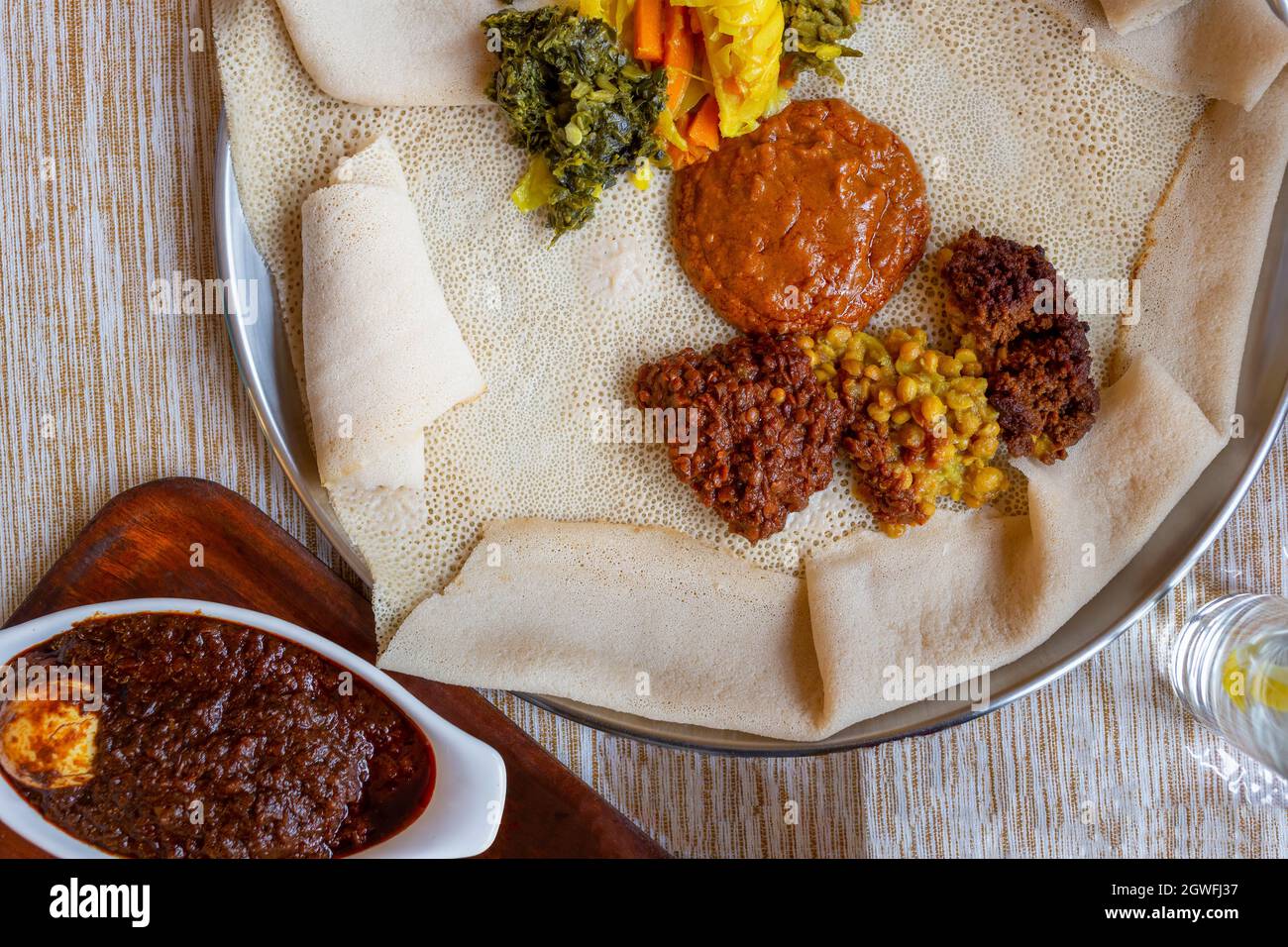 Top down view of traditional vegetarian injera meal, with shiro ...