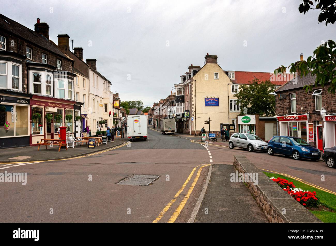 The main street through the small market town of Wooler with many shops ...