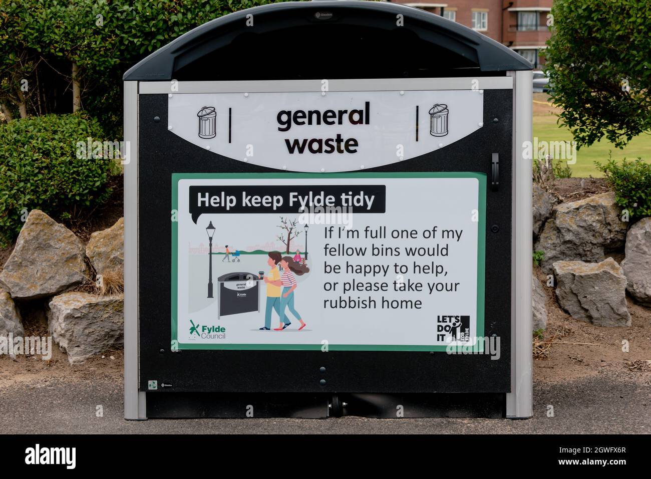 A large public rubbish bin or wheelie bin housing street furniture with ...